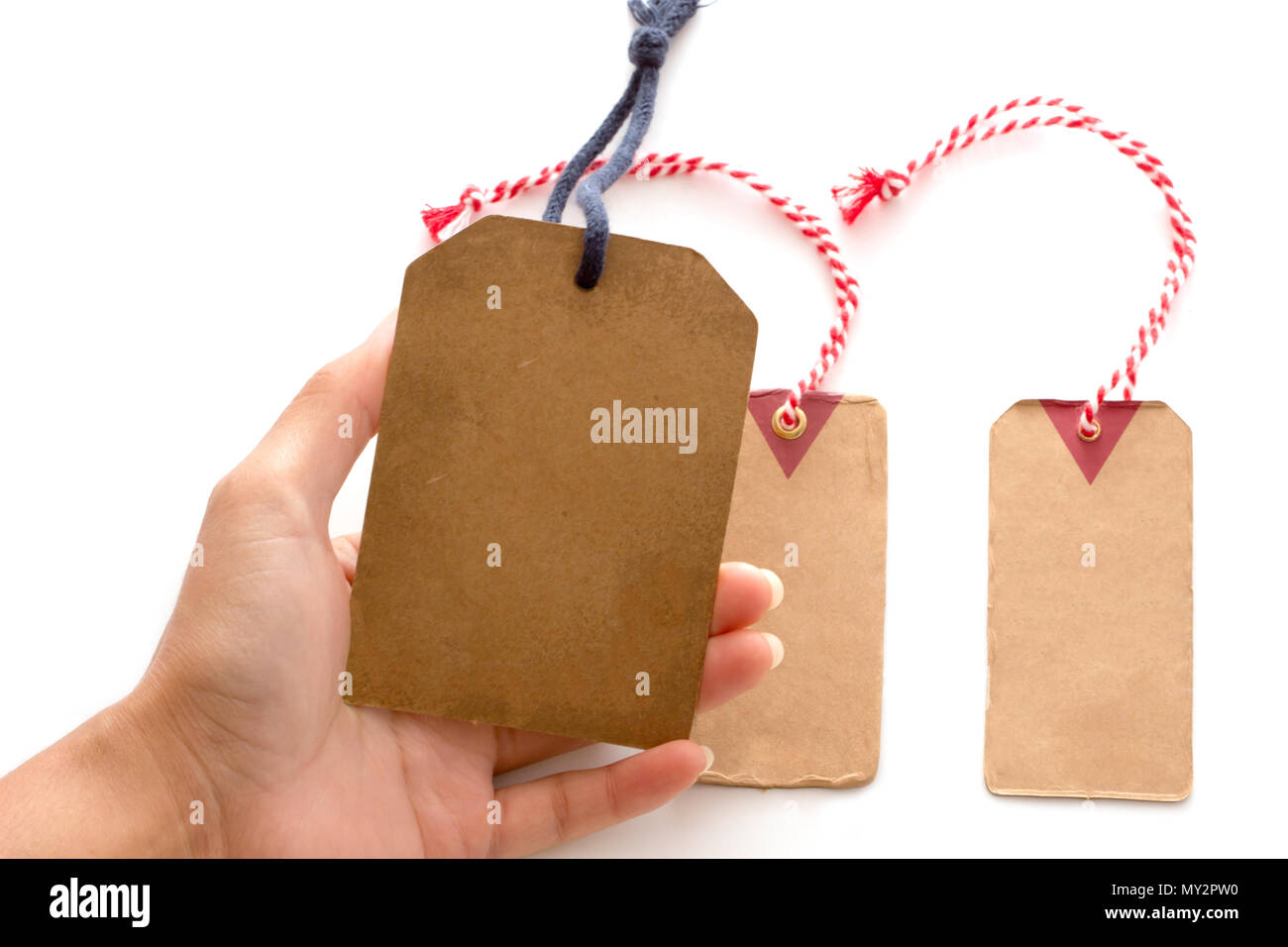 Closeup of hands holding blank brown cardboard price tag or label,price ...