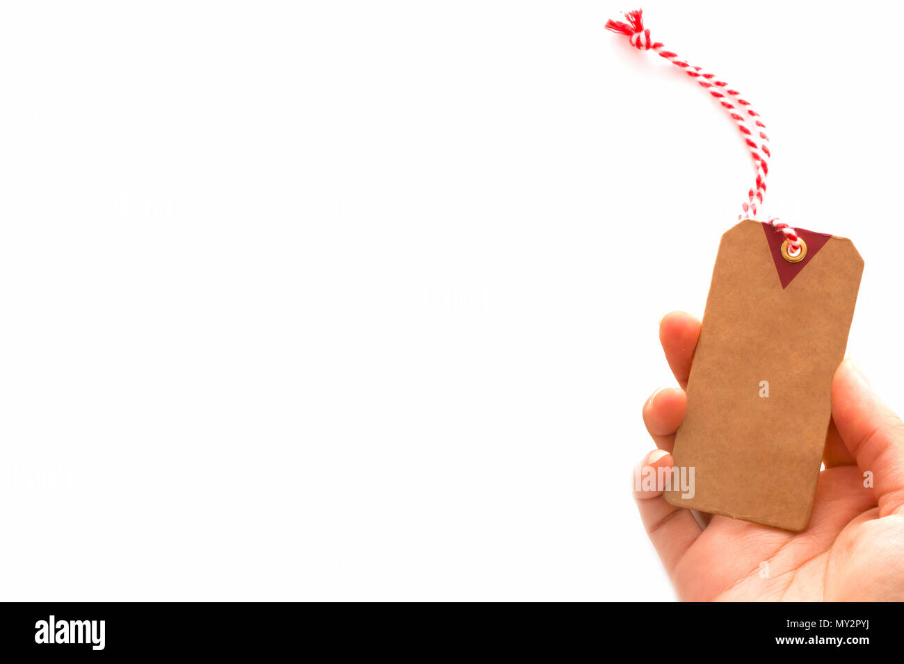 Closeup of hands holding old brown paper tag or label, cardboard price ...