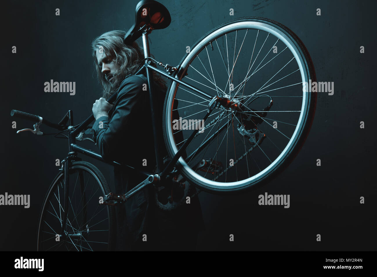 Man carrying bicycle on shoulder hi-res stock photography and images ...