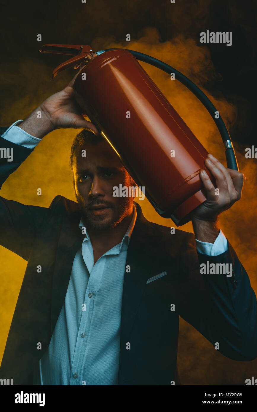 Young man fire extinguisher fire hi-res stock photography and images ...