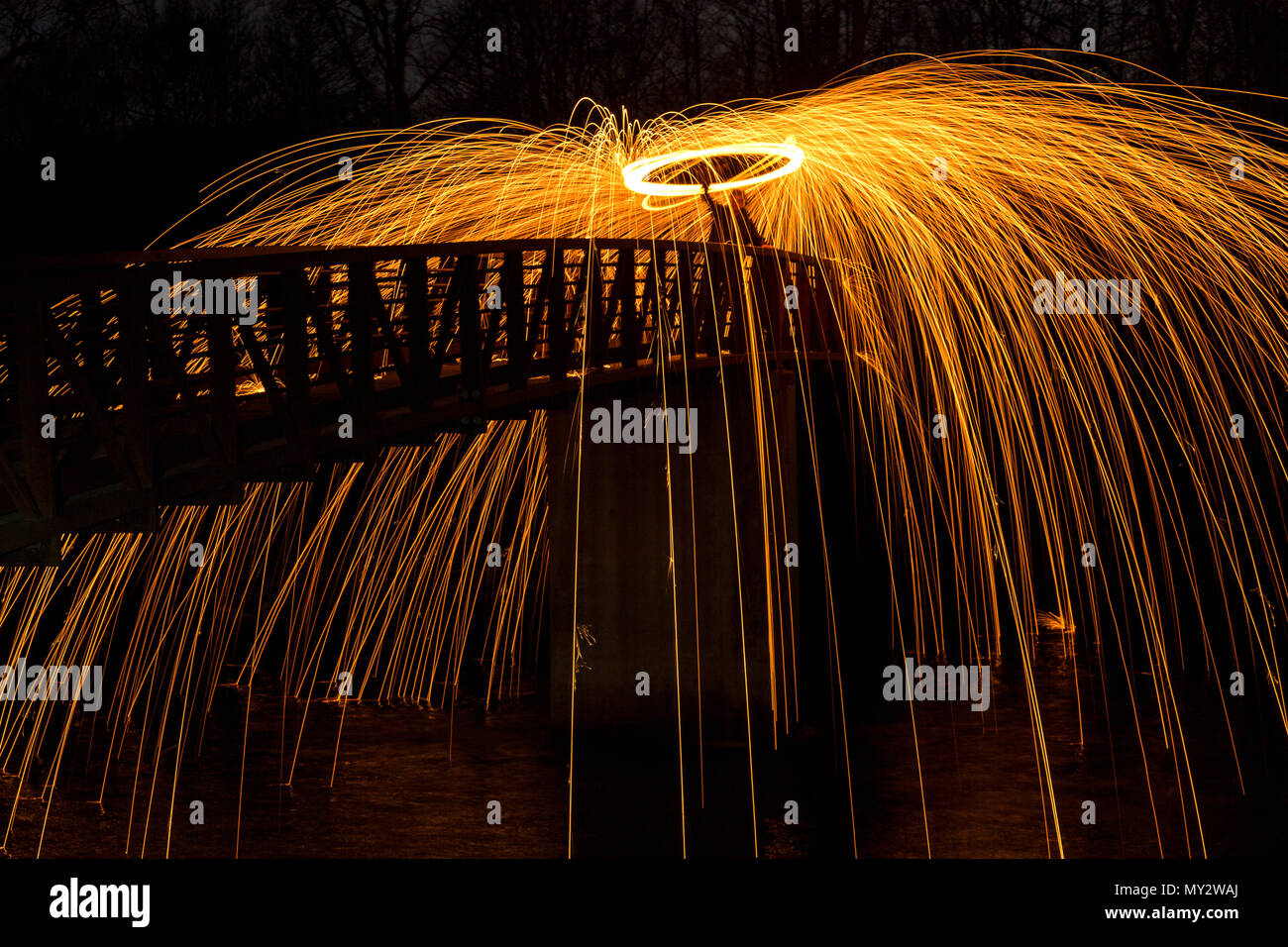 Light painting at night whirling steel wool burning at the end of a ...