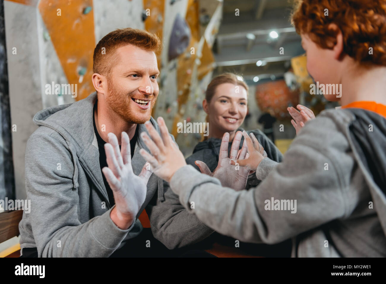 Dad and little son showing each other palms covered in talcum powder ...