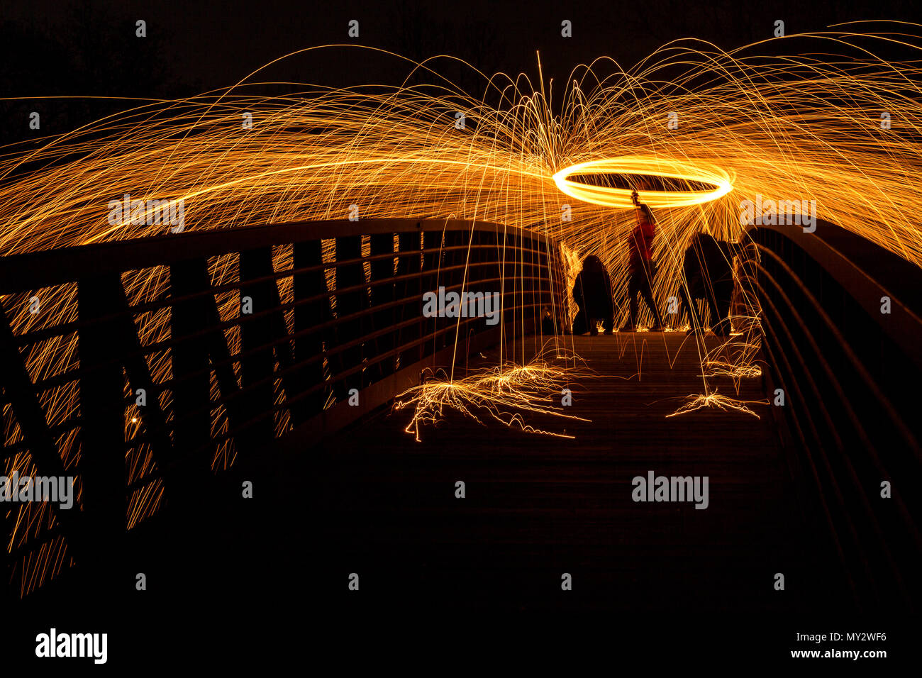 Light painting at night whirling steel wool burning at the end of a ...