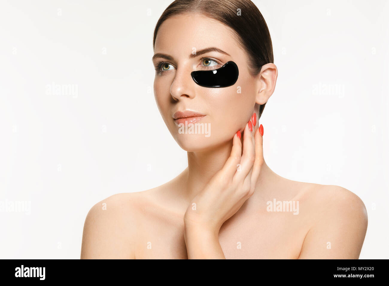 Young beautiful woman applying a mask for the face of the therapeutic ...