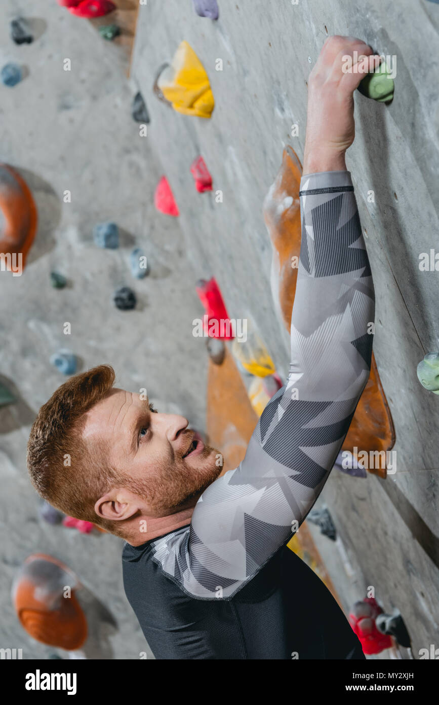 Side view of man climbing wall hi-res stock photography and images - Alamy