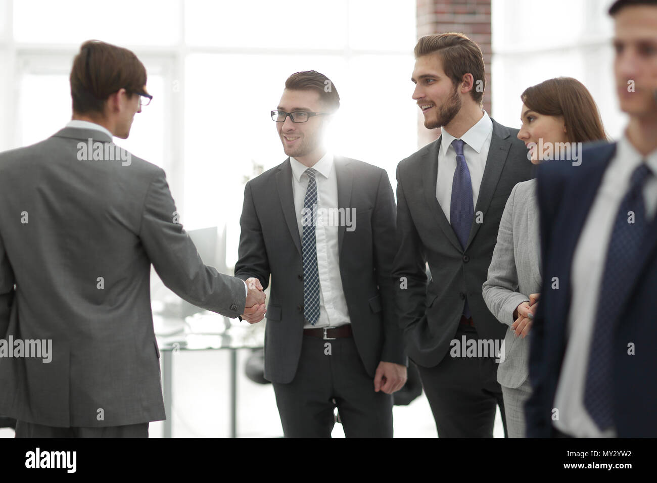Confident young people, handshake and smile Stock Photo - Alamy
