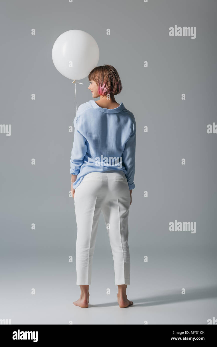 back view of beautiful girl with white balloon, isolated on grey Stock ...