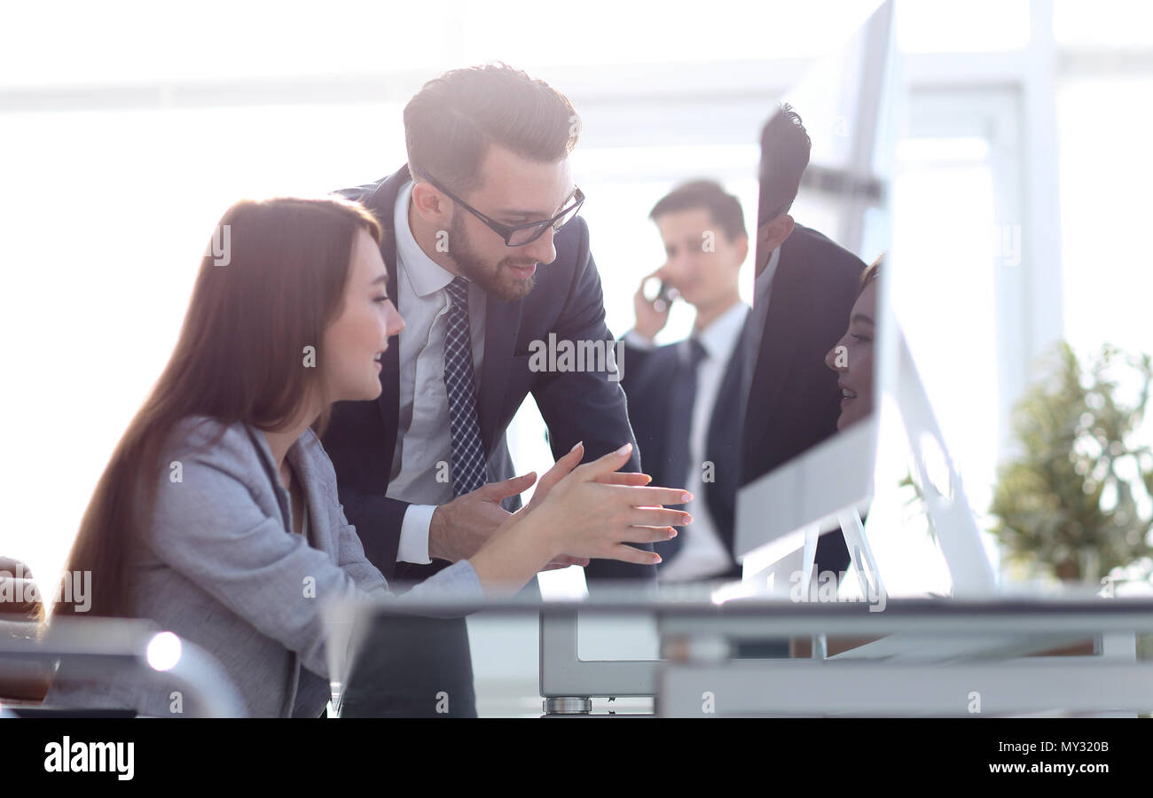 Manager talking with an employee Stock Photo - Alamy