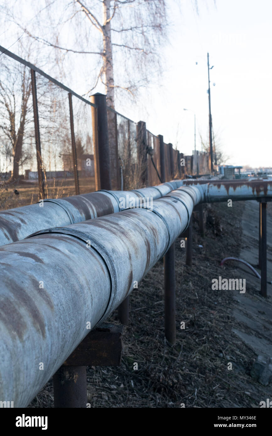 old metal industrial tubes and long fence Stock Photo - Alamy