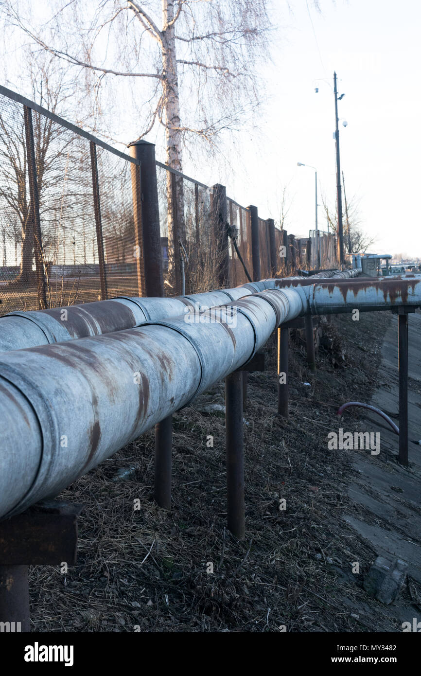 old metal industrial tubes and long fence Stock Photo - Alamy