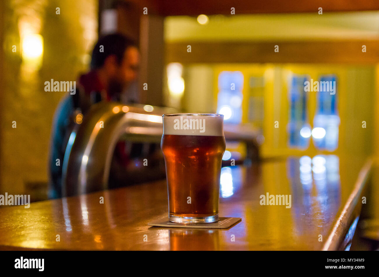 Glass pint of beer on top of bar counter, brewpub, craftbeer Stock ...