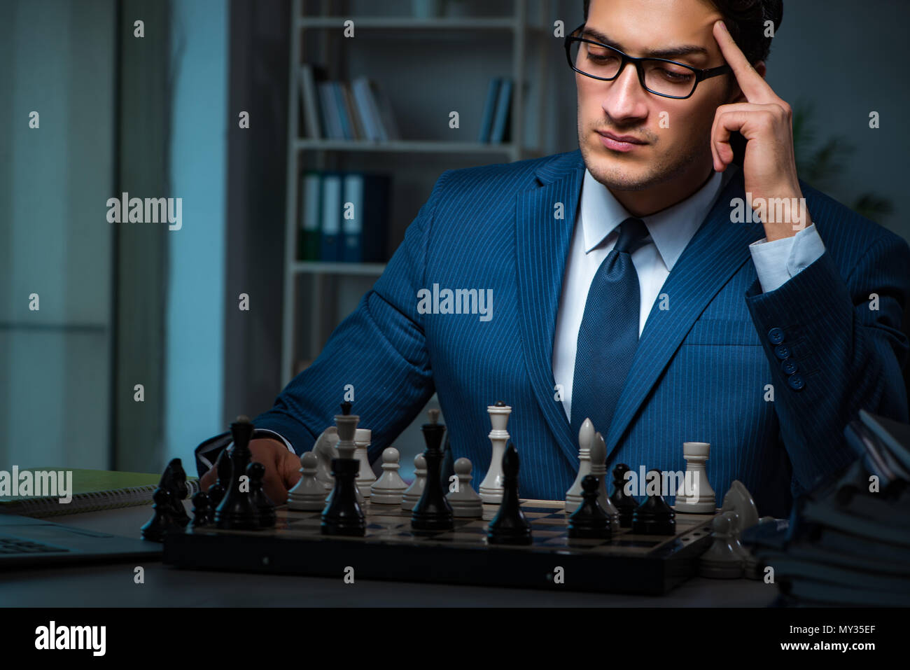 Businessman playing chess in strategy concept Stock Photo - Alamy
