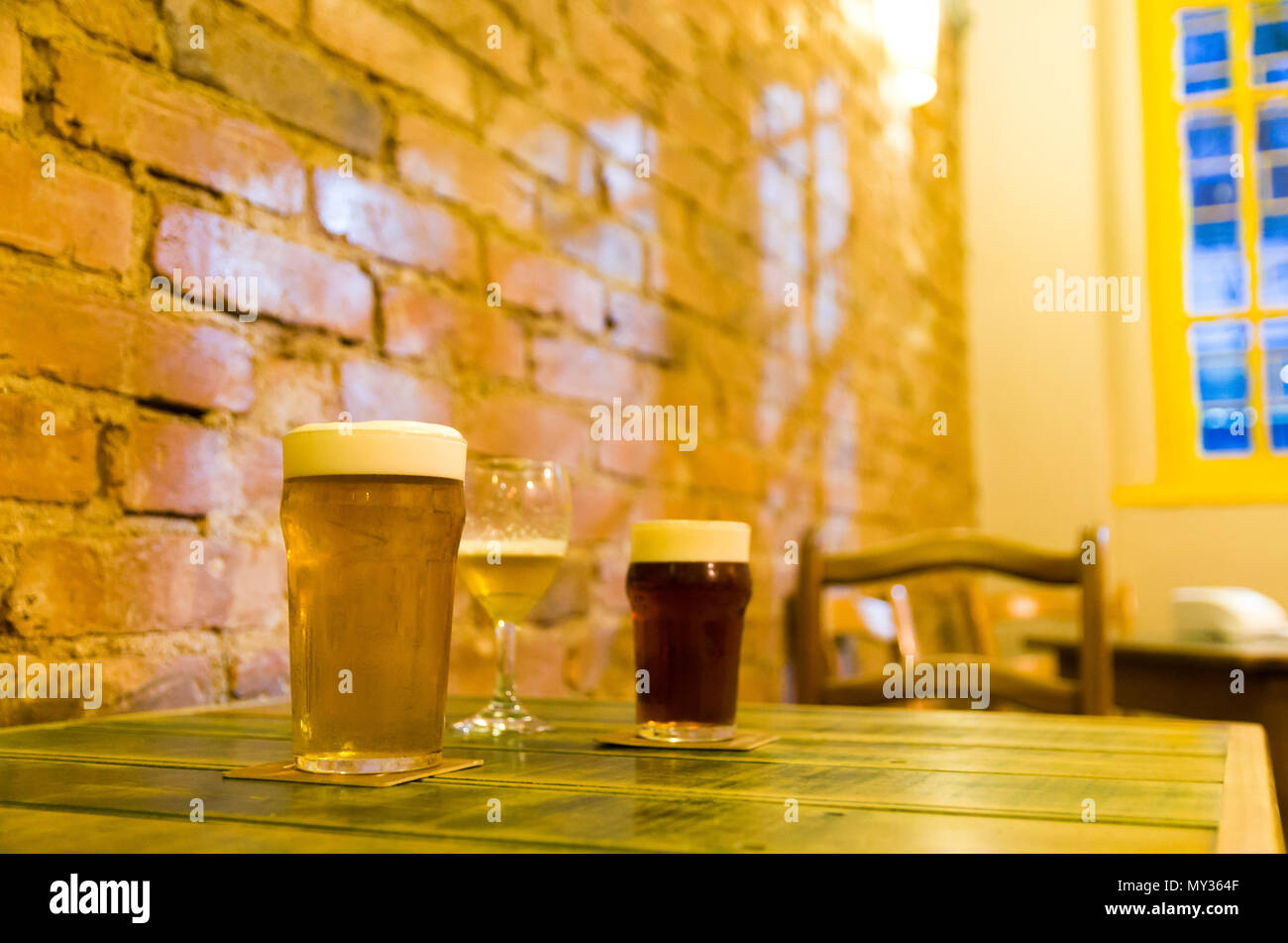 Glass pint of beer on top of bar counter, brewpub, craftbeer Stock ...