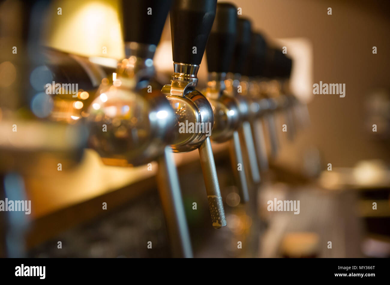 Beer taps on bar counter, brewpub. Craft beer Stock Photo - Alamy