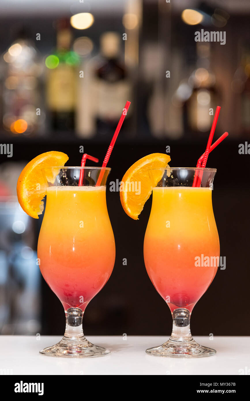 Two cocktails with orange stand on the bar counter Stock Photo - Alamy