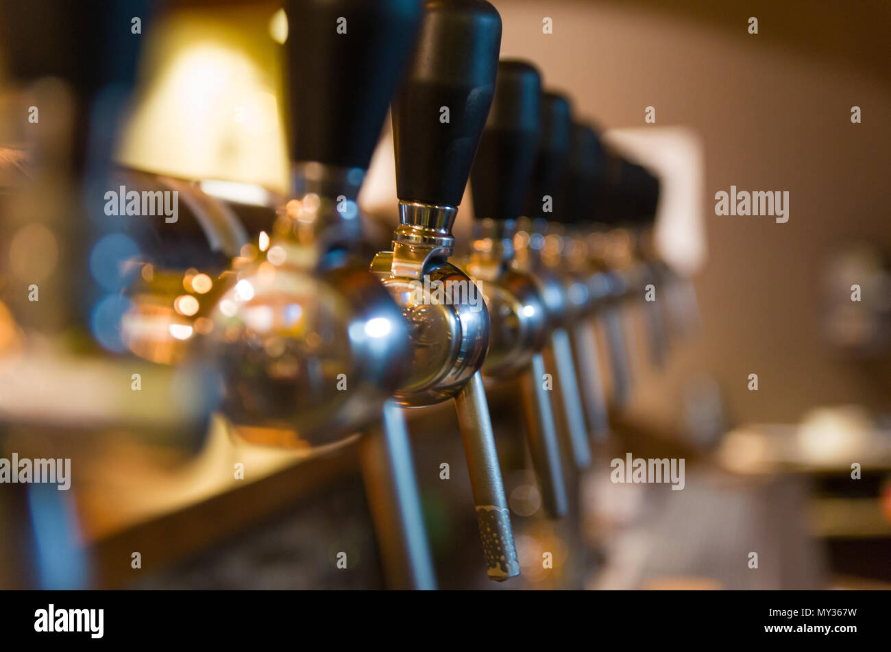 Beer taps on bar counter, brewpub. Craft beer Stock Photo - Alamy