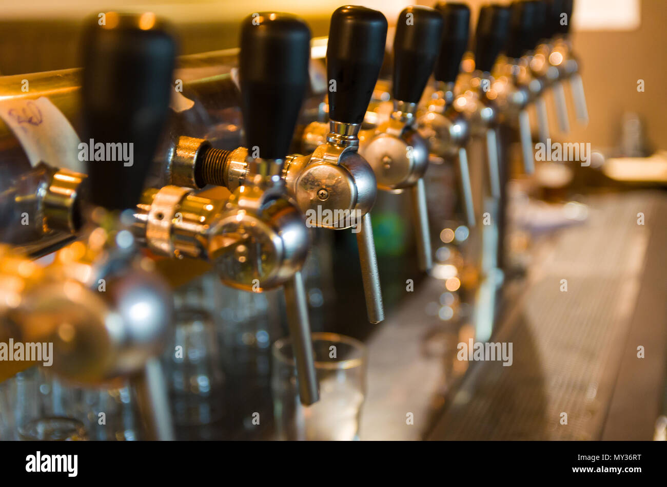 Beer taps on bar counter, brewpub. Craft beer Stock Photo - Alamy