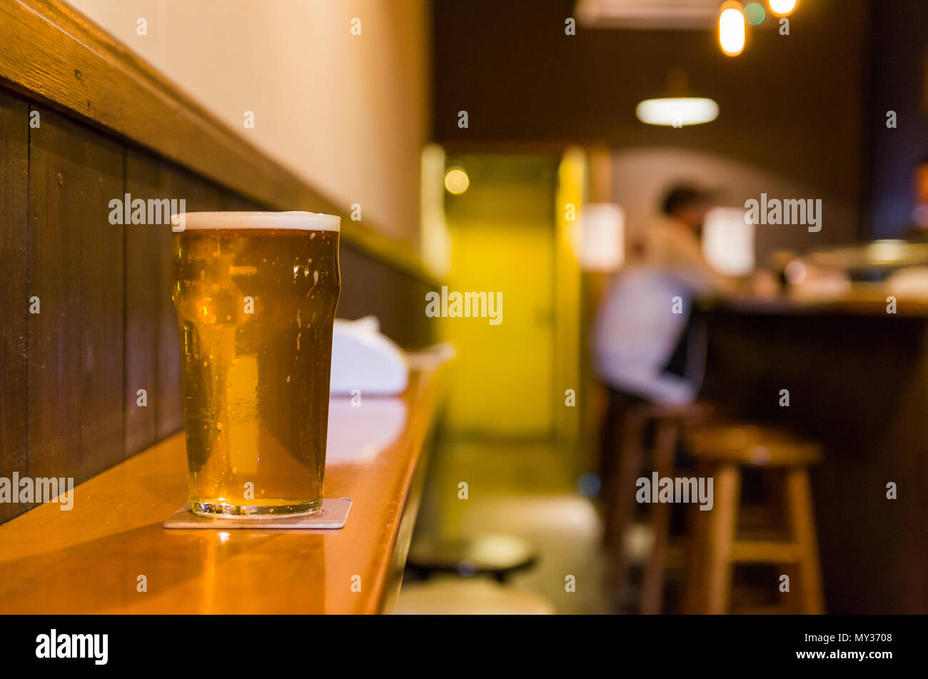 Glass pint of beer on top of bar counter, brewpub, craftbeer Stock ...