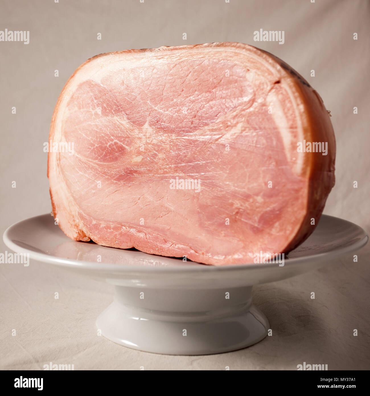 Typical italian cooked ham on a white background in the studio Stock ...