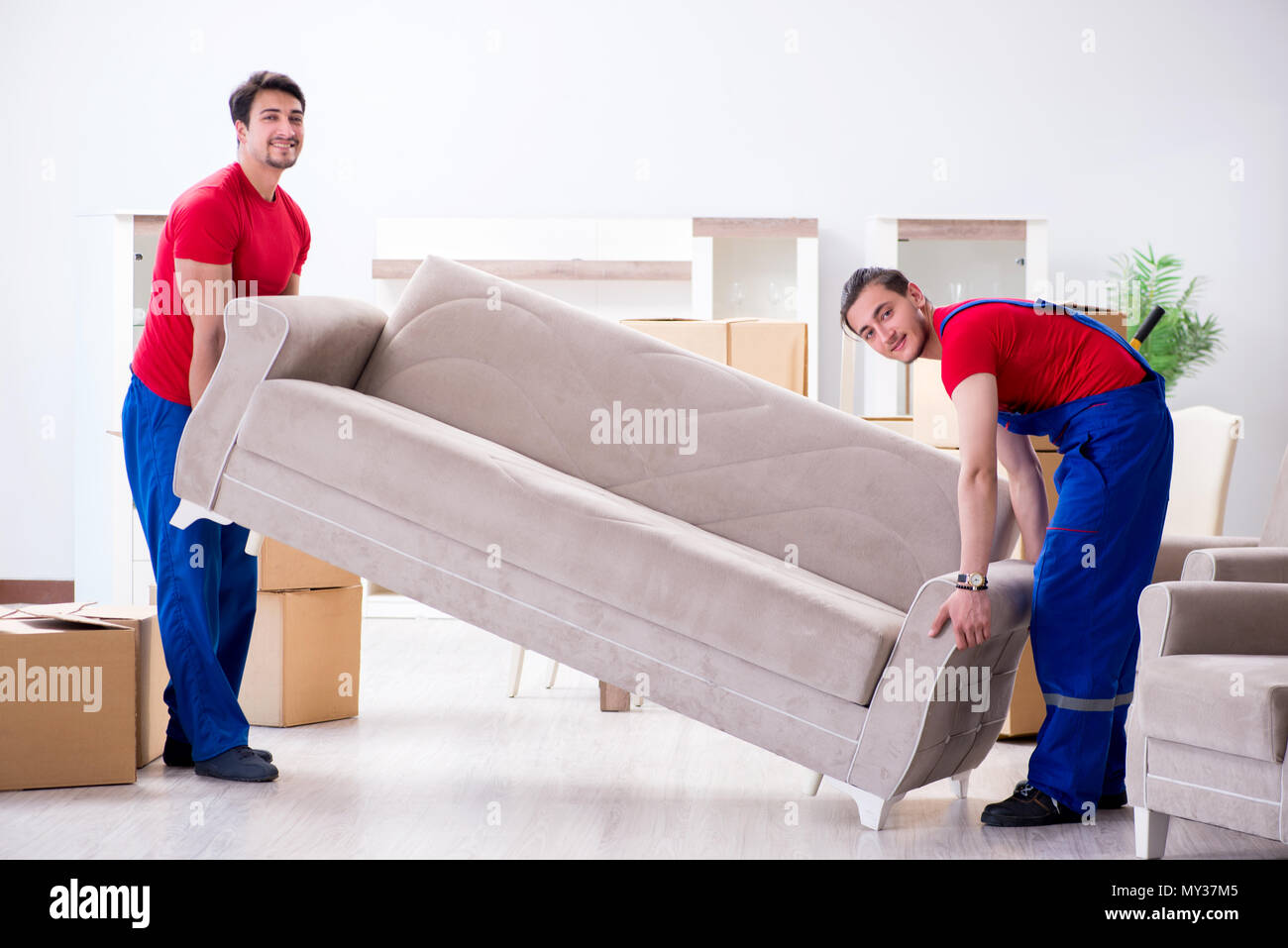 Two contractor employees moving personal belongings Stock Photo - Alamy