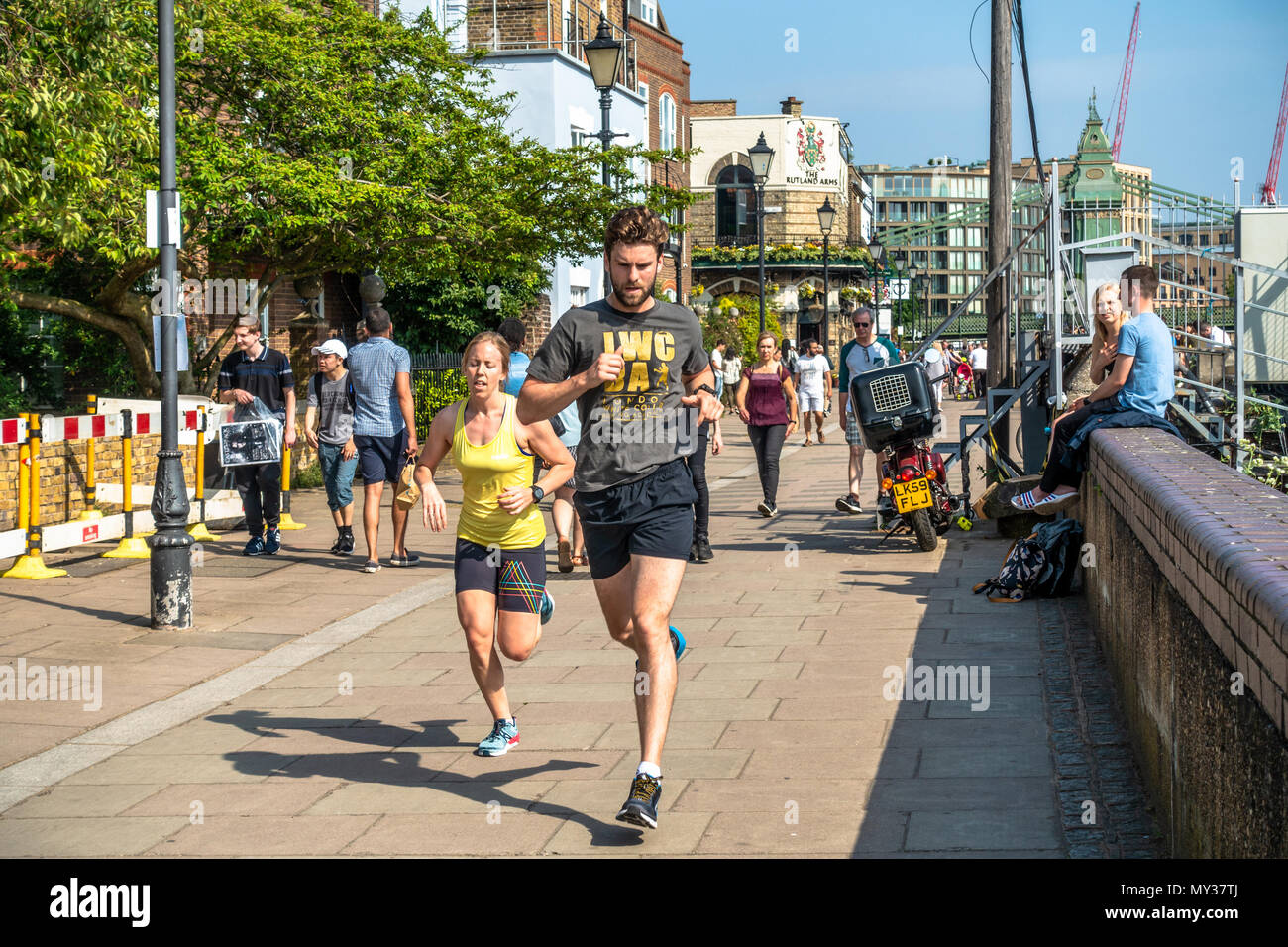 A man and woman run along The Lower Mall, a path running alongside The ...