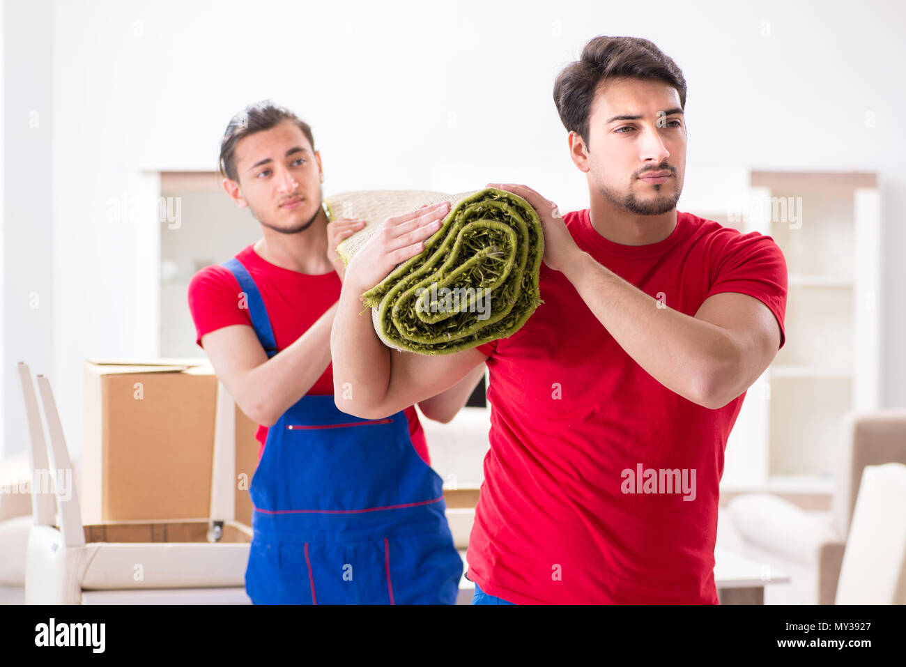 Two contractor employees moving personal belongings Stock Photo - Alamy