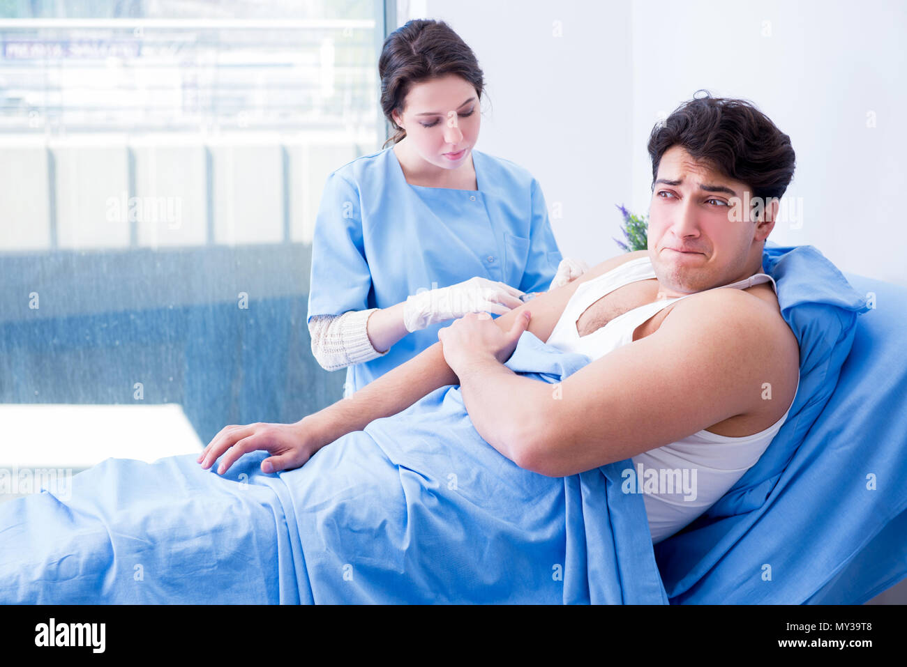 Doctor doing medical injection in hospital room Stock Photo - Alamy