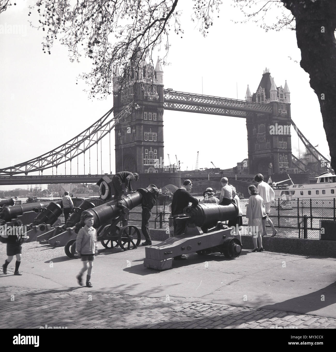 1950s, on the riverbank by the river Thames, children playing on the ...