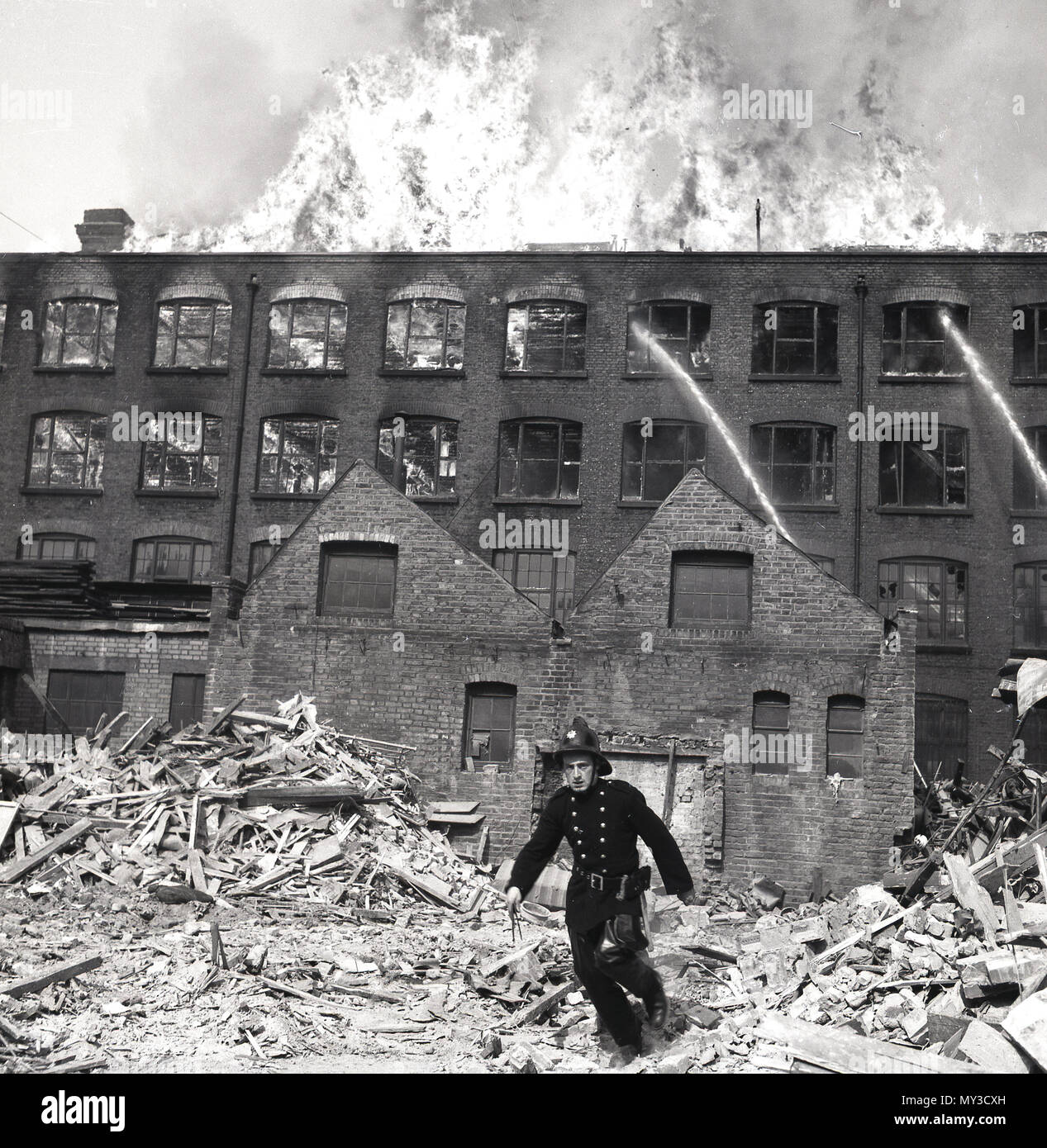 Firefighters spray water wreckage hi-res stock photography and images ...