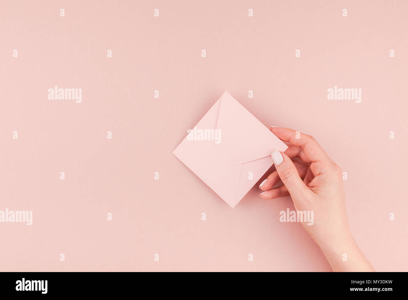 Creative image of woman hand holding small love letter with copy space ...