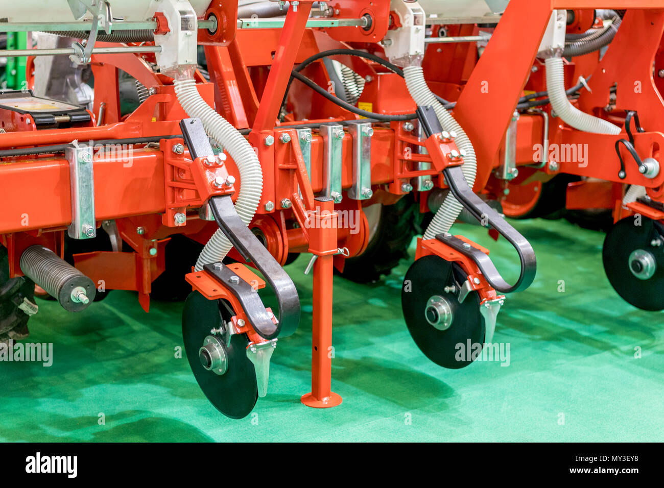 Plow modern tech red tractor close up on an agricultural field ...