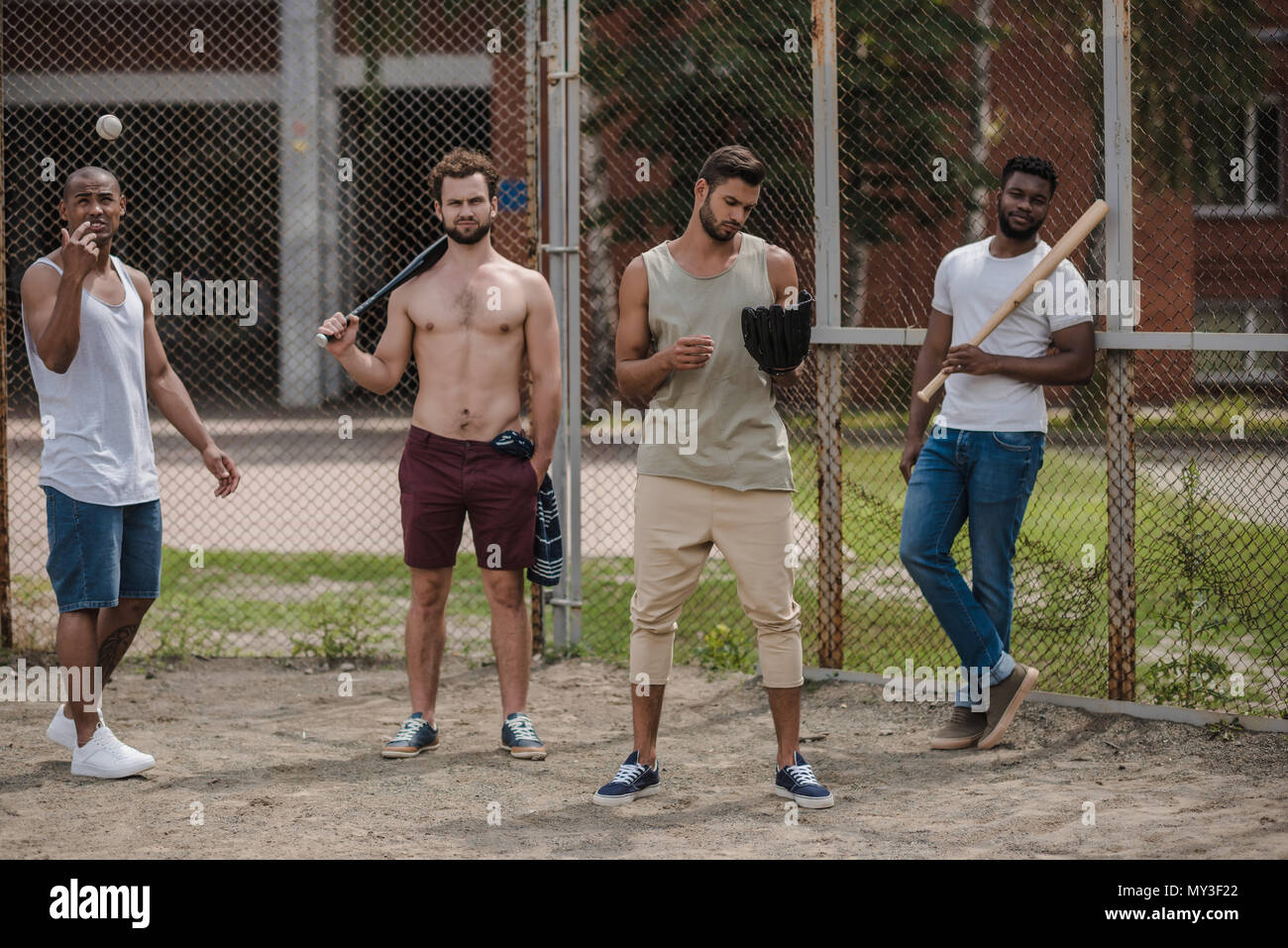 group of young multiethnic male baseball players on court Stock Photo ...