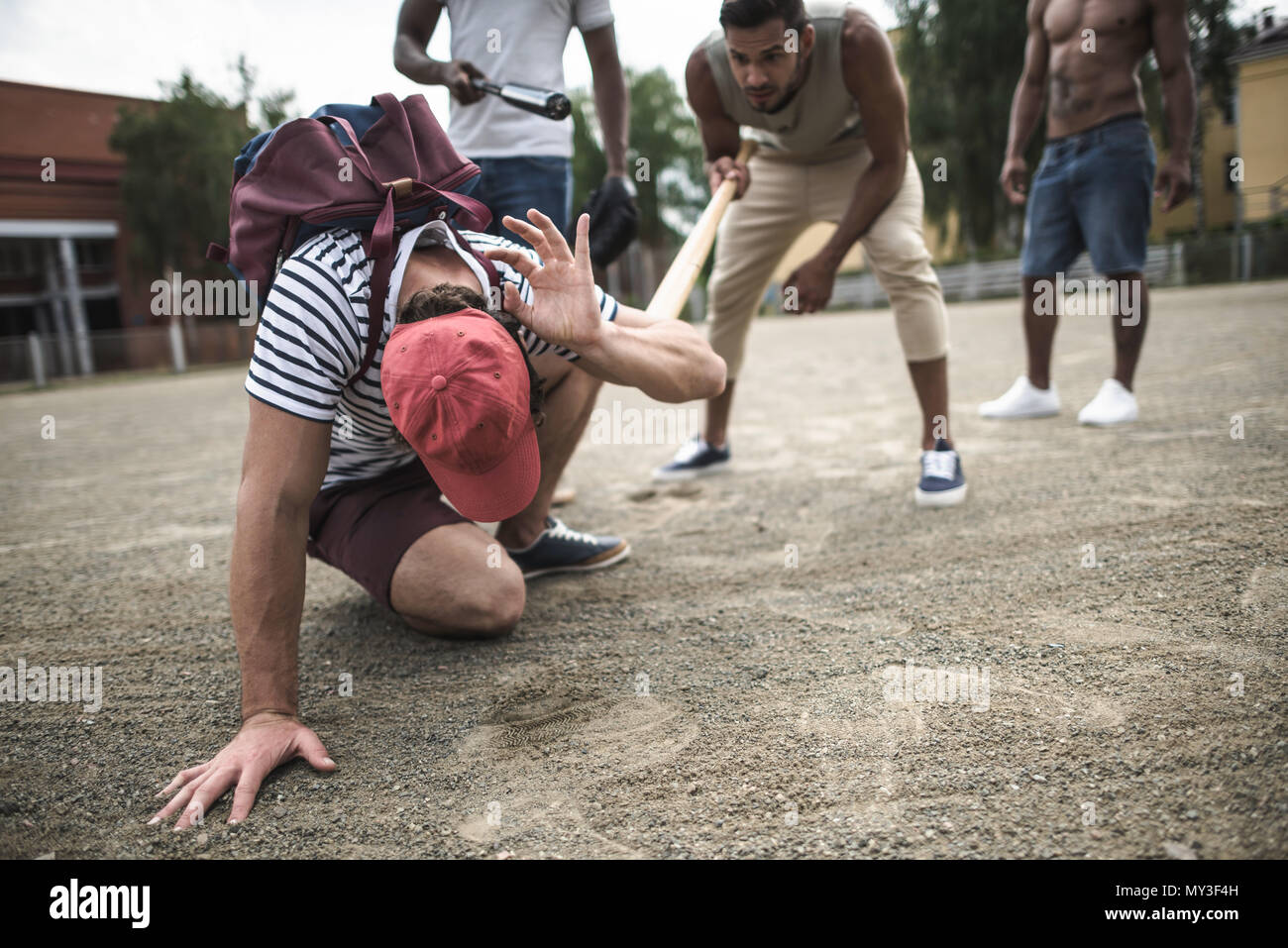 group of multiethnic men attacking other one with baseball bats Stock ...