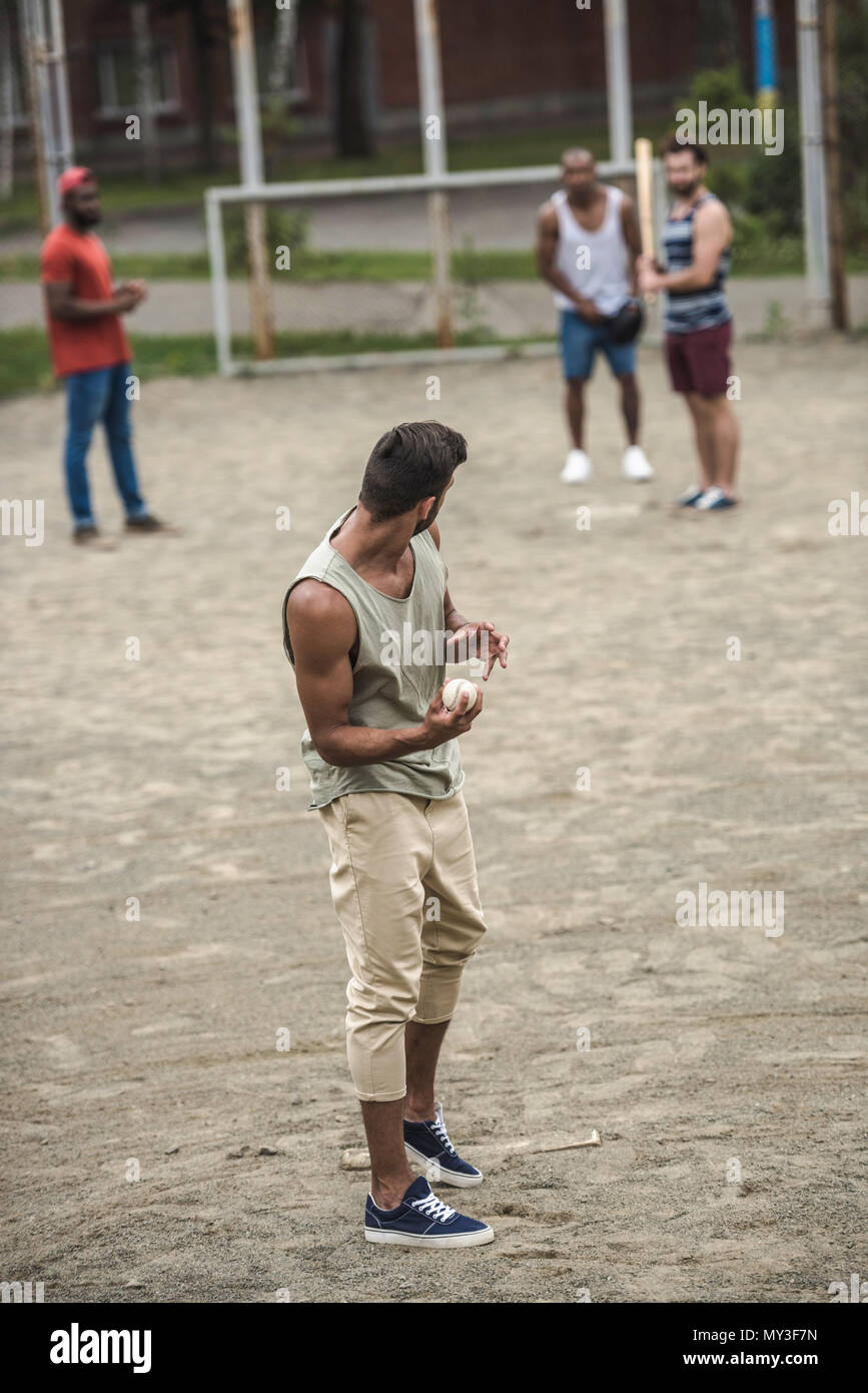 group of young multiethnic men playing baseball on court Stock Photo ...