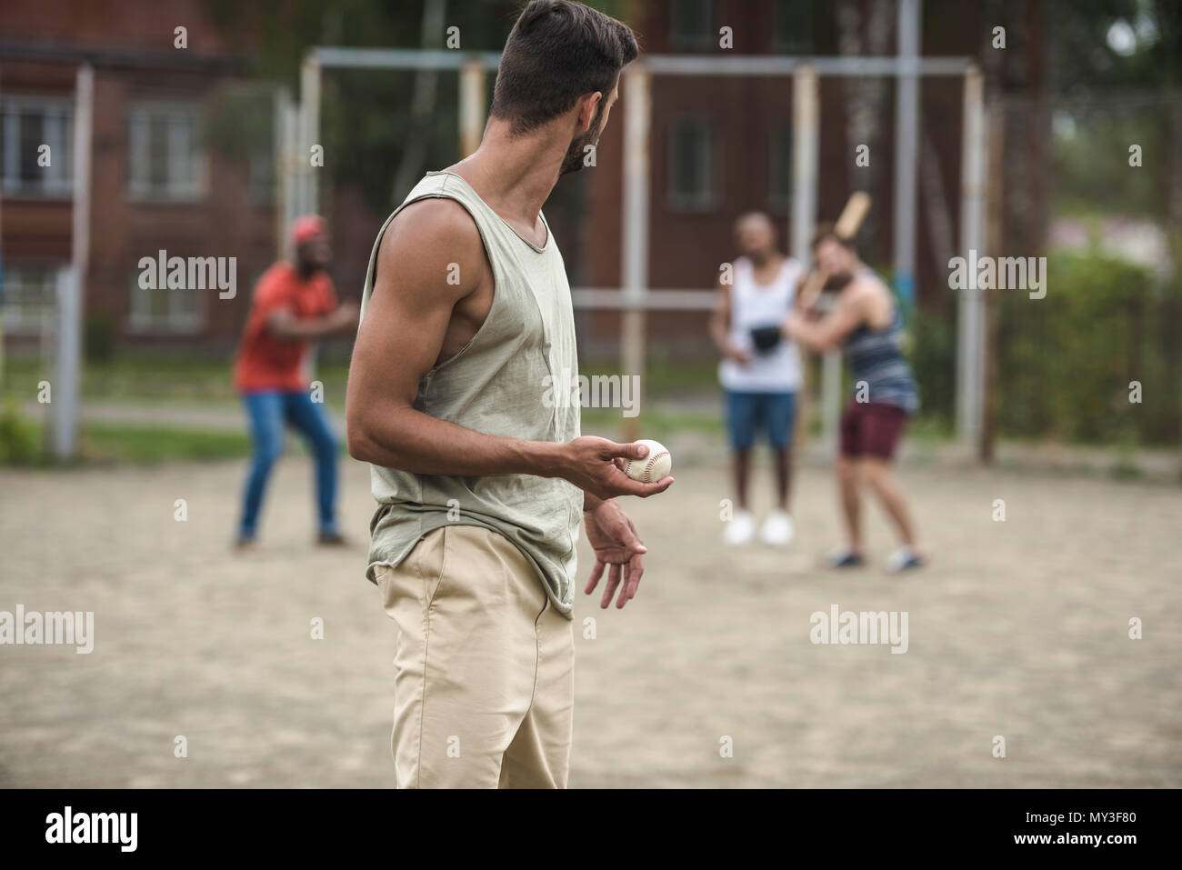 group of young multiethnic men playing baseball on court Stock Photo ...