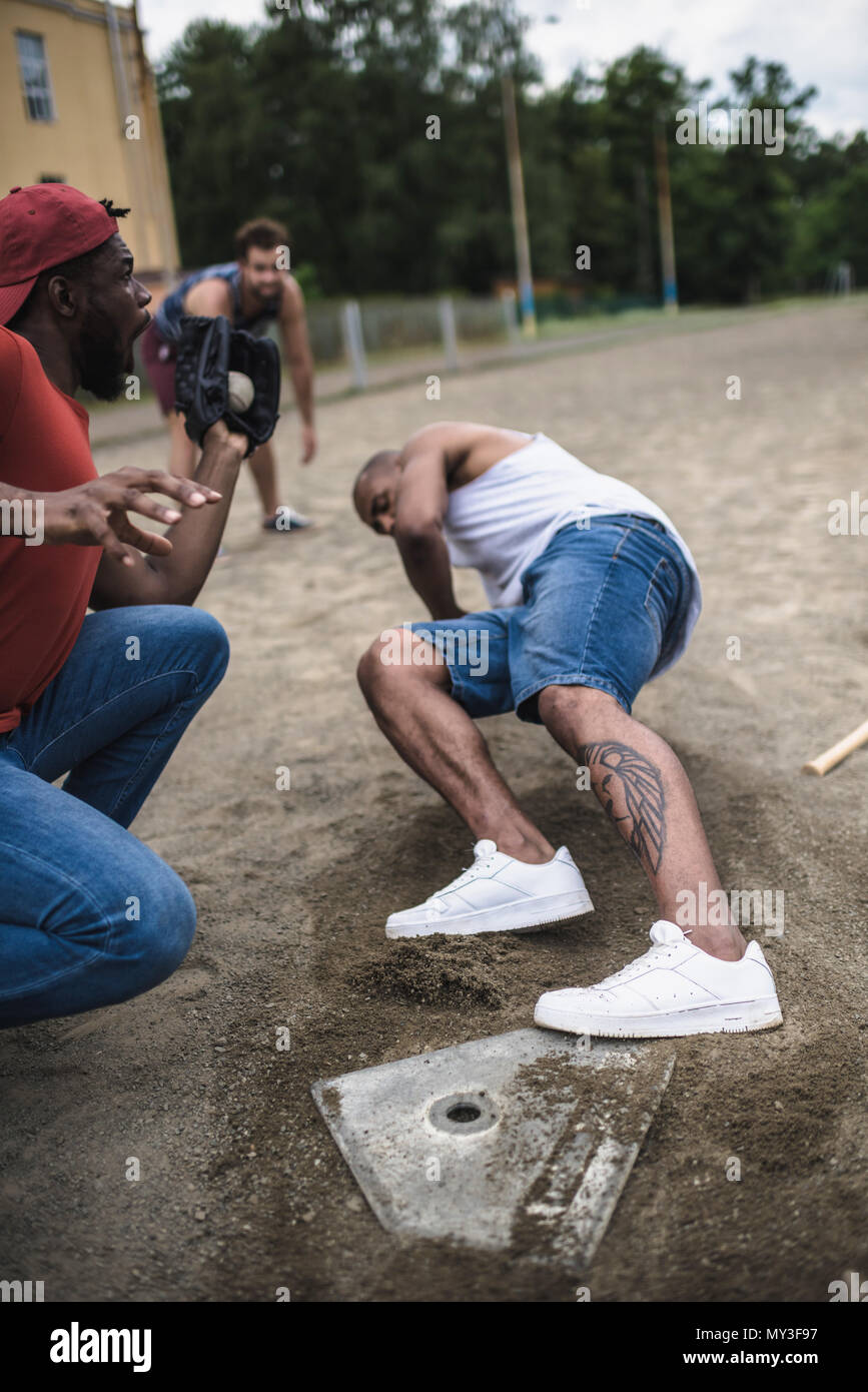group of young multiethnic men playing baseball on court Stock Photo ...