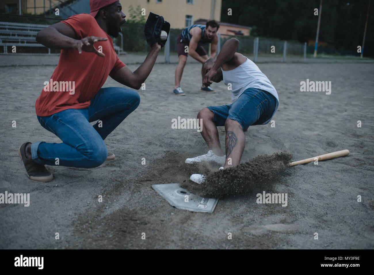 group of young multiethnic men playing baseball on court Stock Photo ...