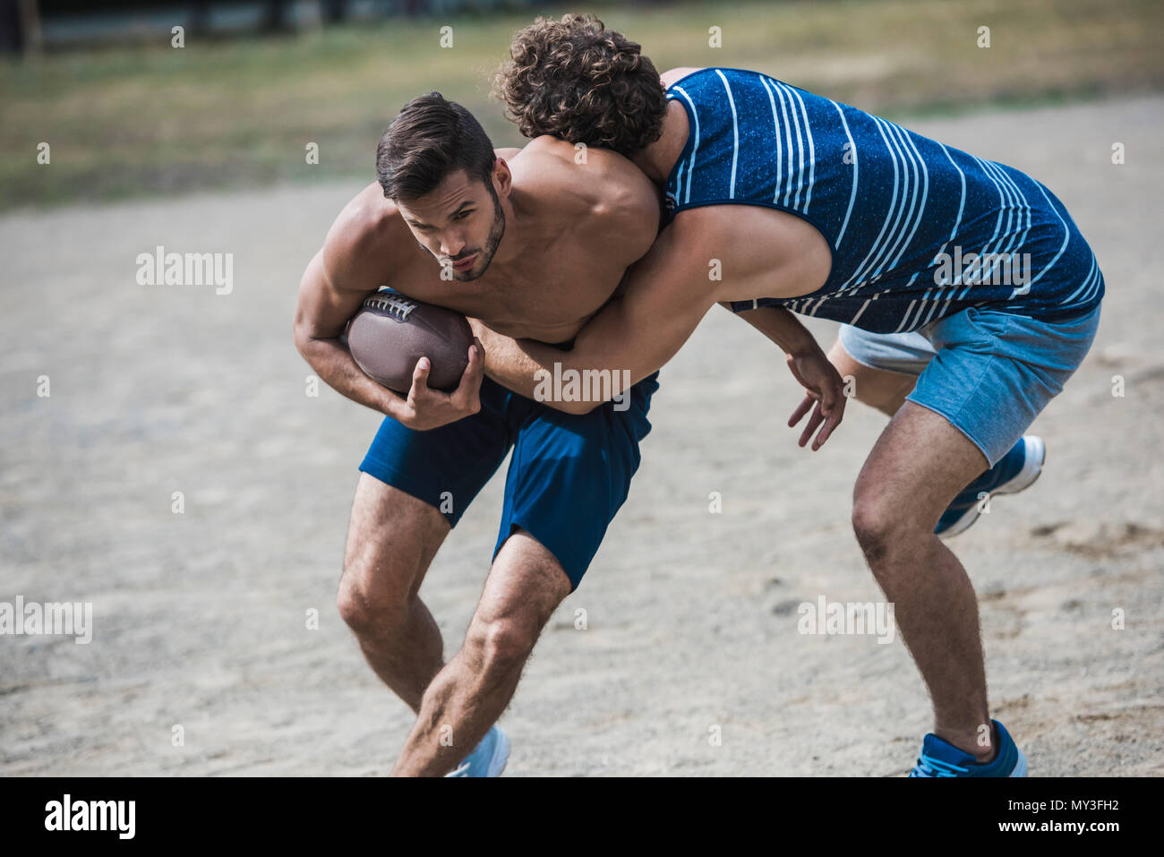 group of young handsome men playing football on court Stock Photo - Alamy