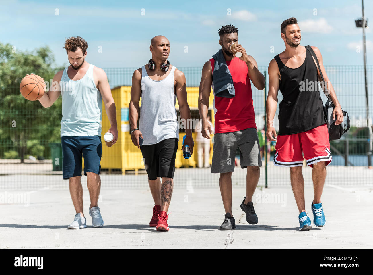 multiethnic group of athletic basketball players walking on court Stock ...