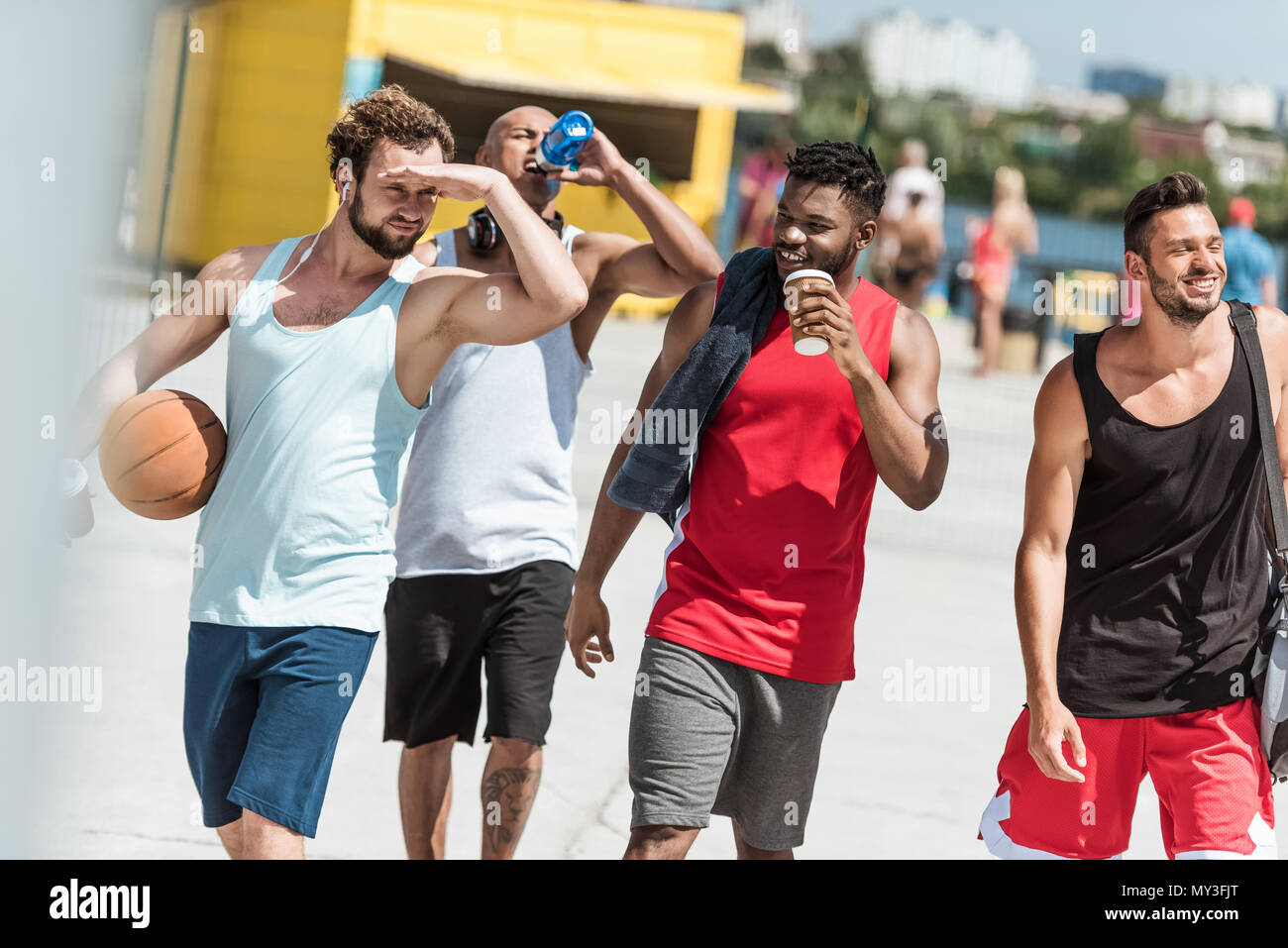 multiethnic group of athletic basketball players walking on court Stock ...
