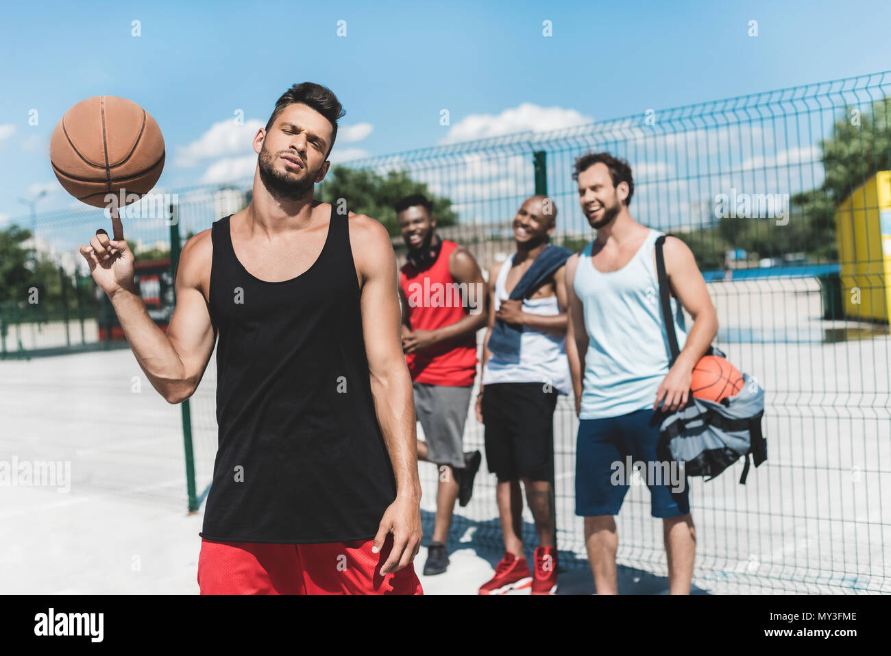 multicultural basketball team spending time on basketball court Stock ...
