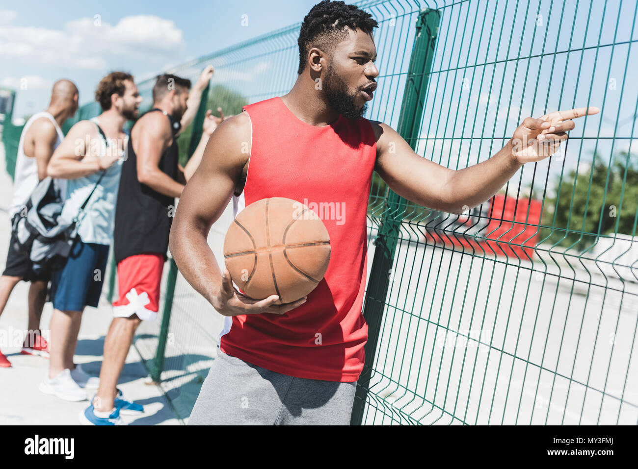 multicultural basketball team spending time on basketball court Stock ...