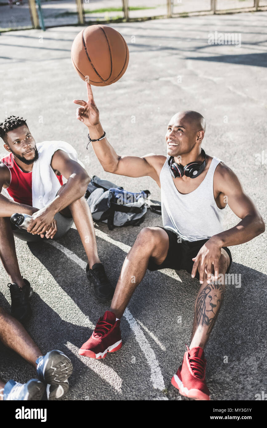 african american basketball players resting after game on court ...
