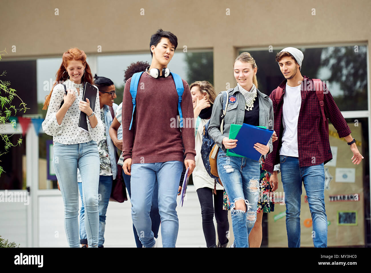 College students chatting while walking on campus between classes Stock ...