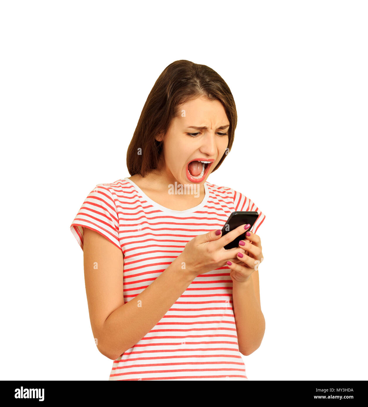 angry young girl screaming on mobile phone. emotional girl isolated on ...