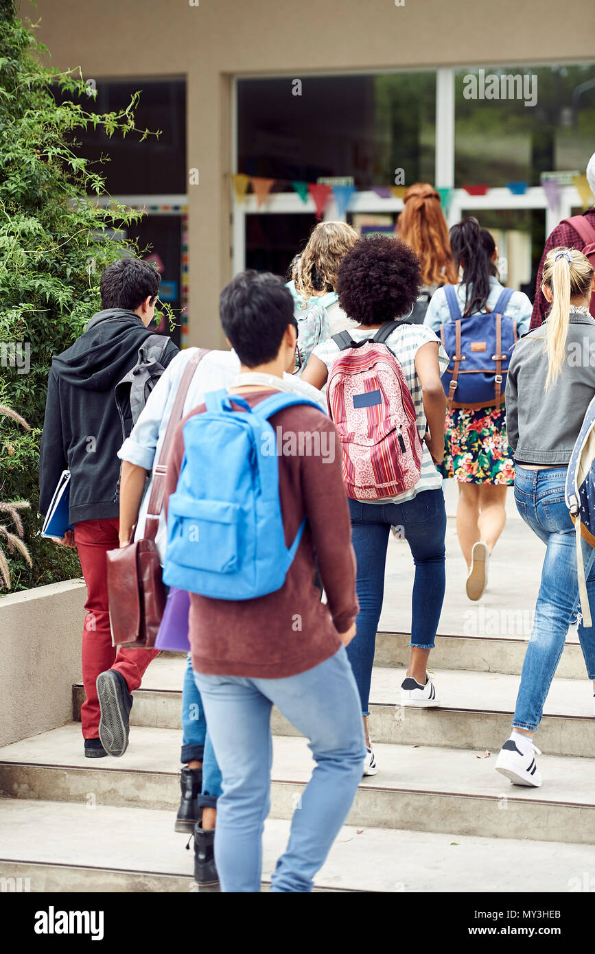 College students walking toward campus building, rear view Stock Photo ...