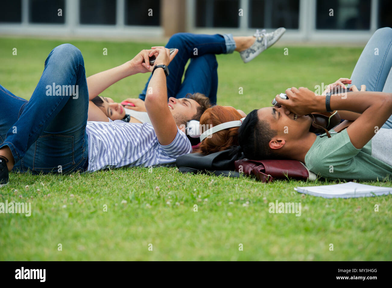 College students relaxing together on lawn between classes Stock Photo ...