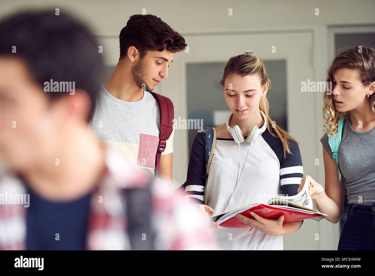 Students studying together in corridor Stock Photo - Alamy