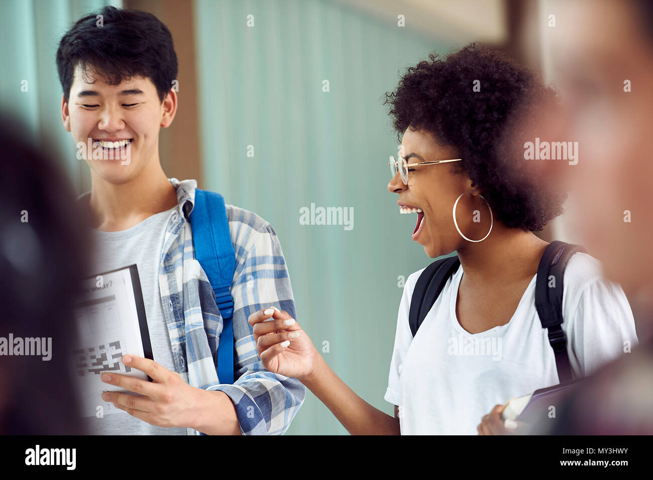 Students laughing together in corridor Stock Photo - Alamy