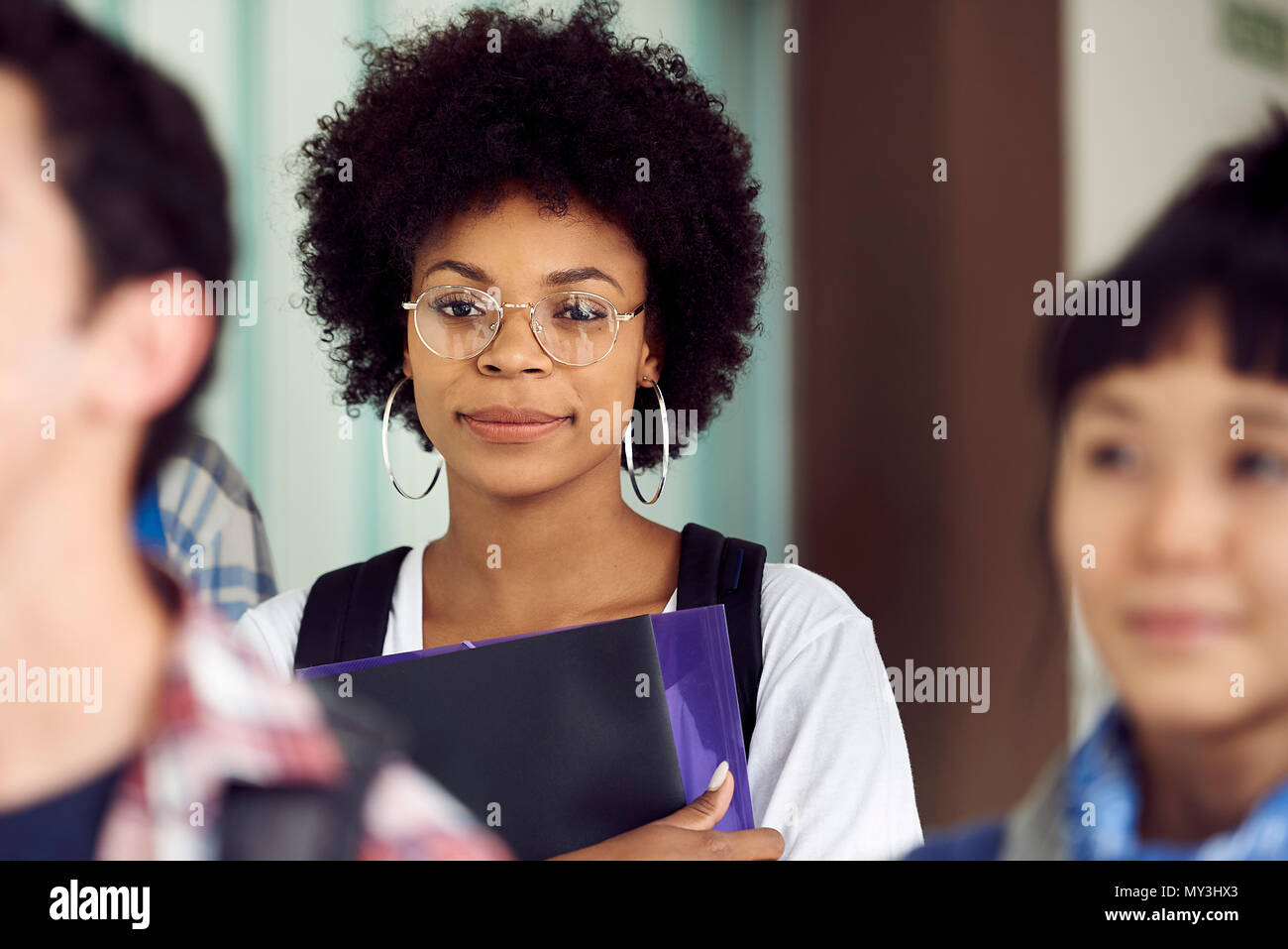 Female college student smiling in corridor, portrait Stock Photo - Alamy